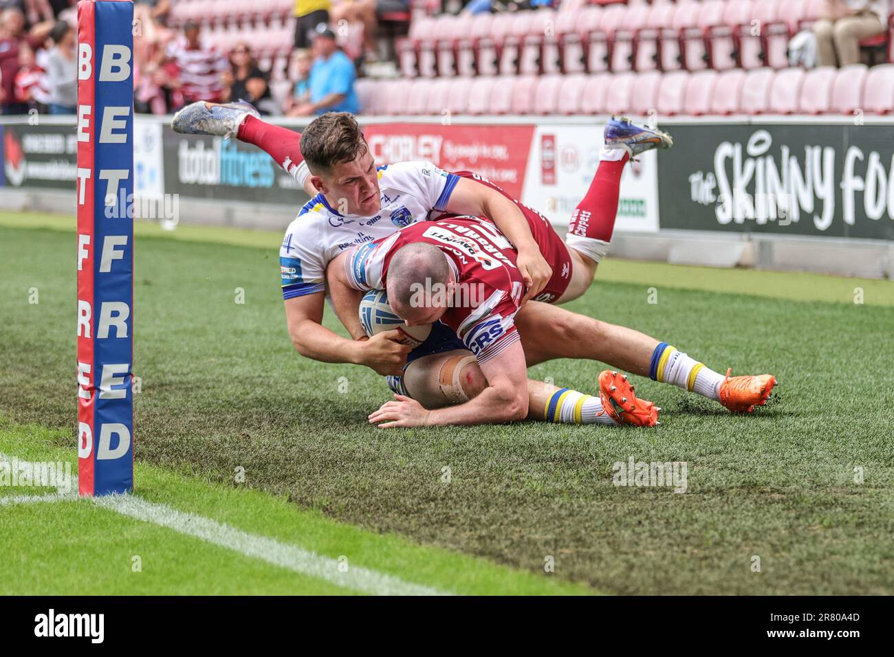 Josh Thewlis #2 of Warrington Wolves takes Liam Marshall #5 of Wigan ...