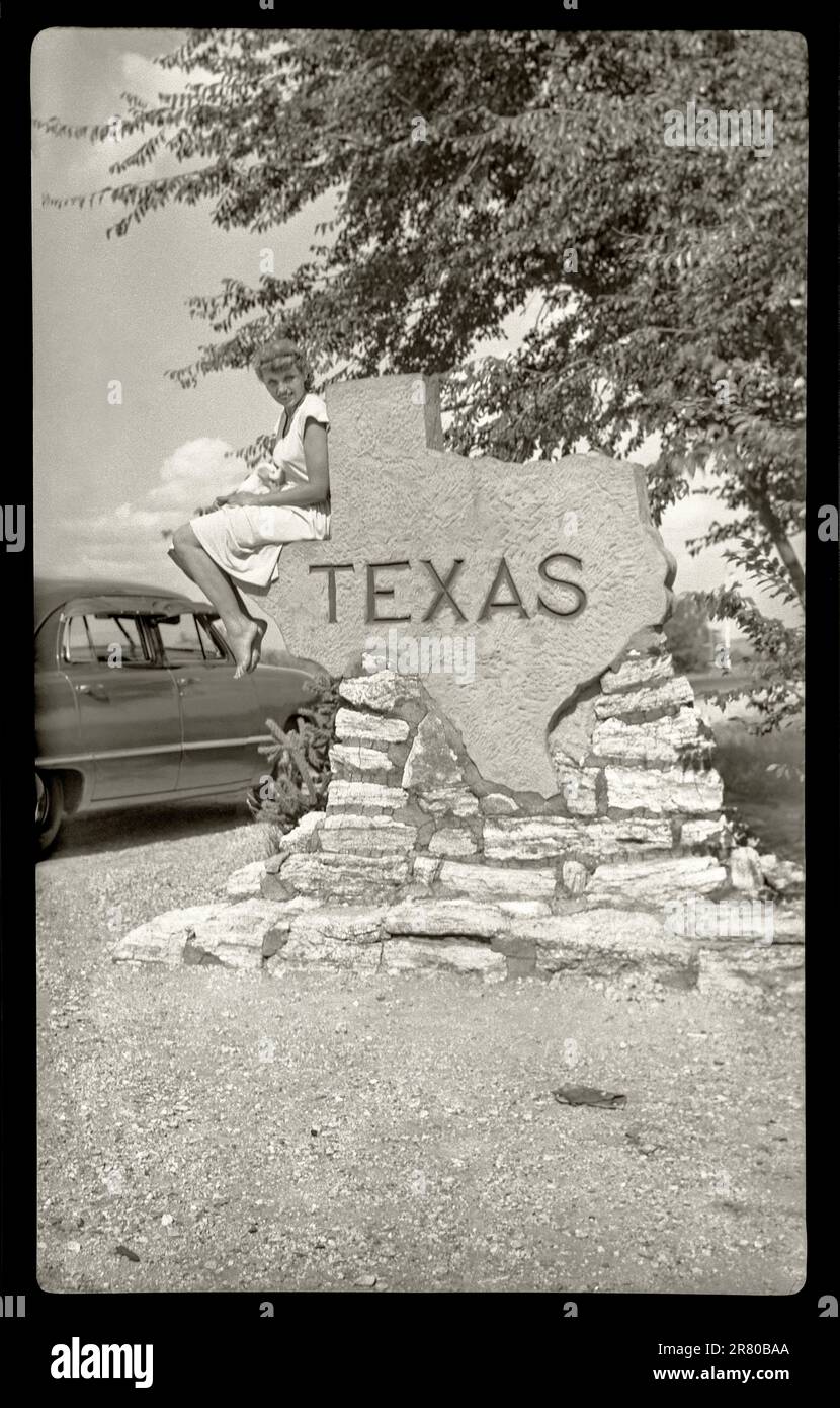 Texas State Sign 1950s. Woman sitting on Texas welcome sign. Image from ...