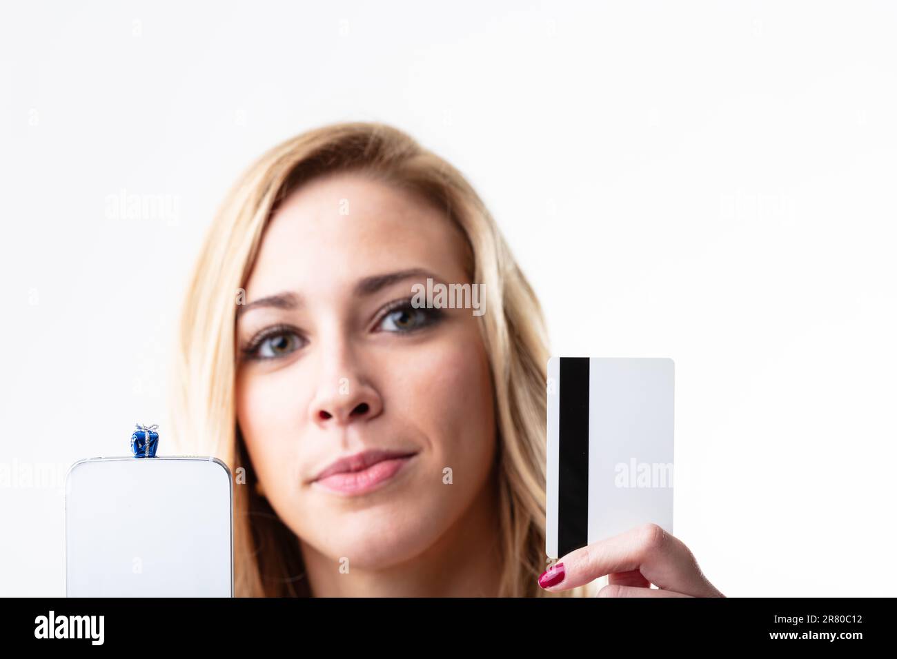 Concept of swift online shopping with a joyful blonde woman, smartphone, credit card. Comfort ...