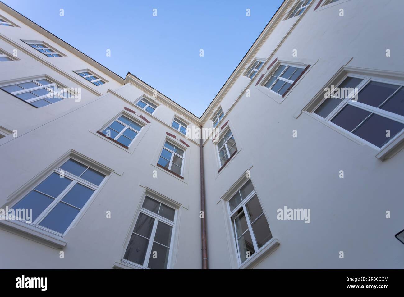 The smooth wall of the building with large windows seen from the very ...