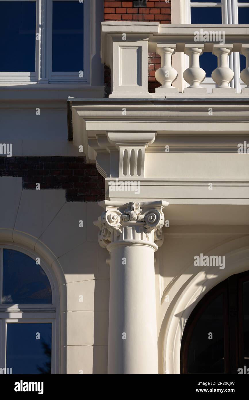 A substantial close-up shows a section of the balcony and columns of ...