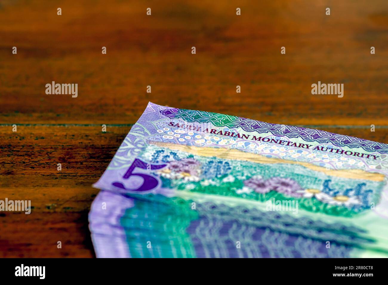 A pile of Saudi Arabia five riyals banknotes money on wooden table ...