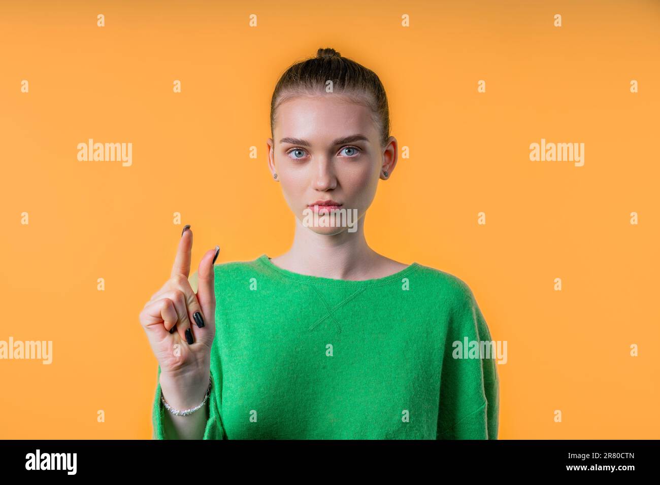 Young woman showing small invisible abstract subject, tiny object sizes ...