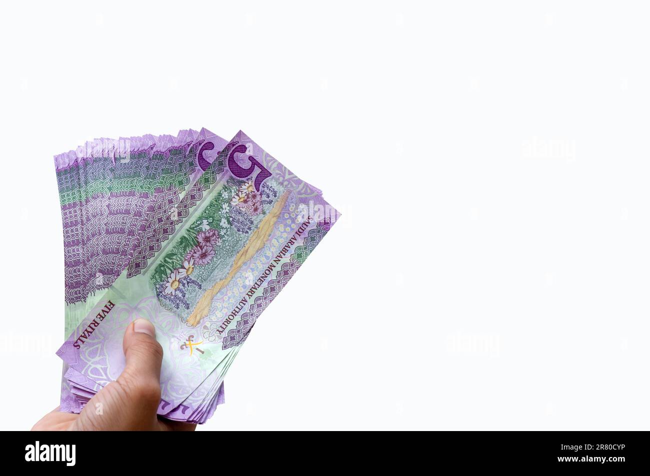Asian children hand with five Riyal, the currency of Saudi Arabia ...