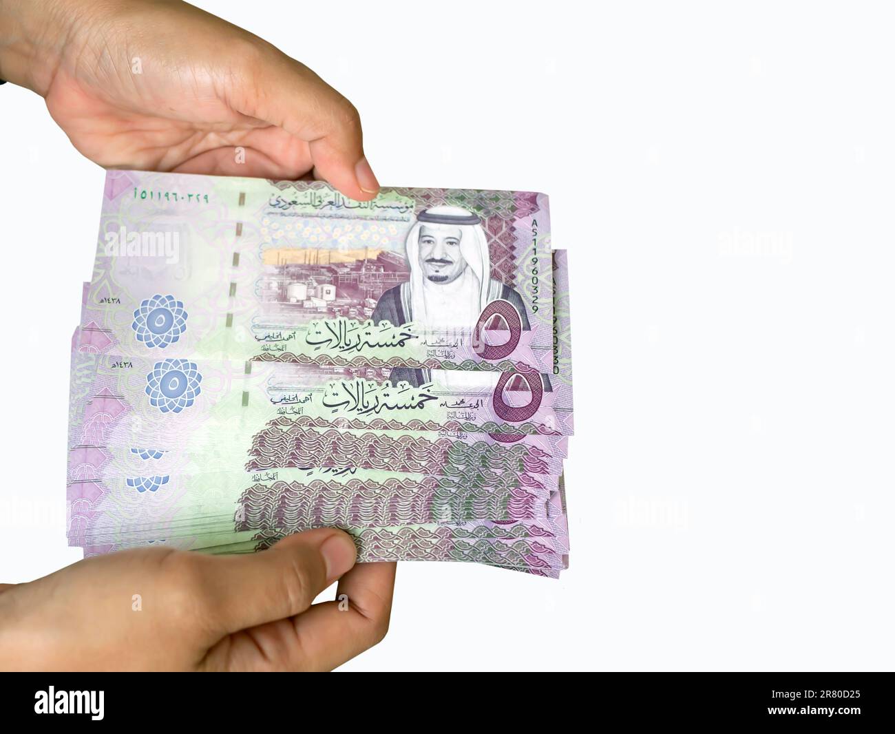Asian children hand with five Riyal, the currency of Saudi Arabia ...