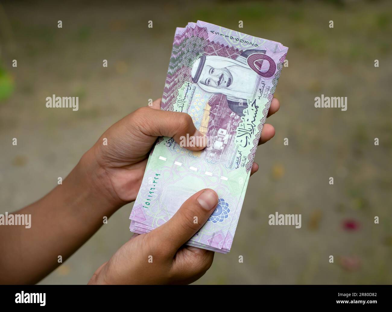 Asian children hand with five Riyal, the currency of Saudi Arabia ...