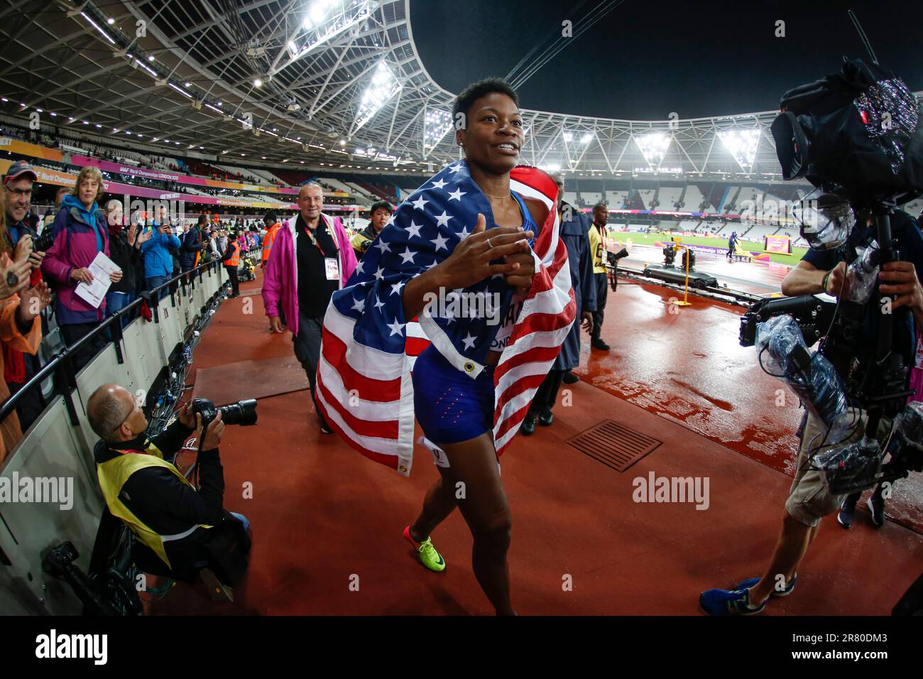 Phyllis Francis celebrating her medal with her country's flag in the ...