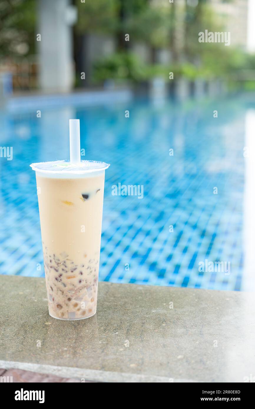 cup of grass jelly near a swimming pool at vertical composition Stock ...