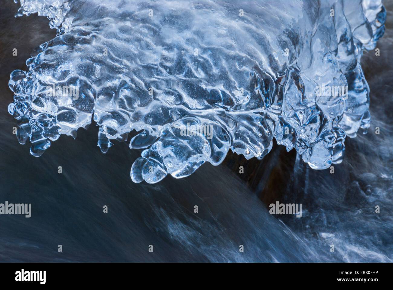 Cold water. remnants of ice with stones. winter nature Stock Photo - Alamy