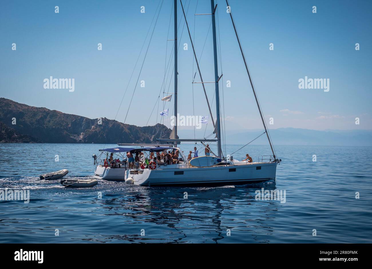 Modern white sailboat sailing slowly in rippling sea Stock Photo - Alamy