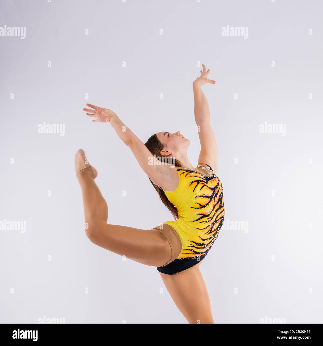 High jump, flight. Little flexible girl, rhythmic gymnastics artist ...