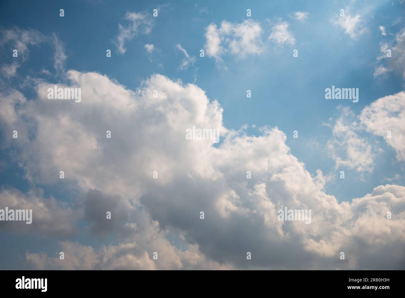 Scattered cloud clusters in a blue sky, blue sky background with white clouds Stock Photo - Alamy