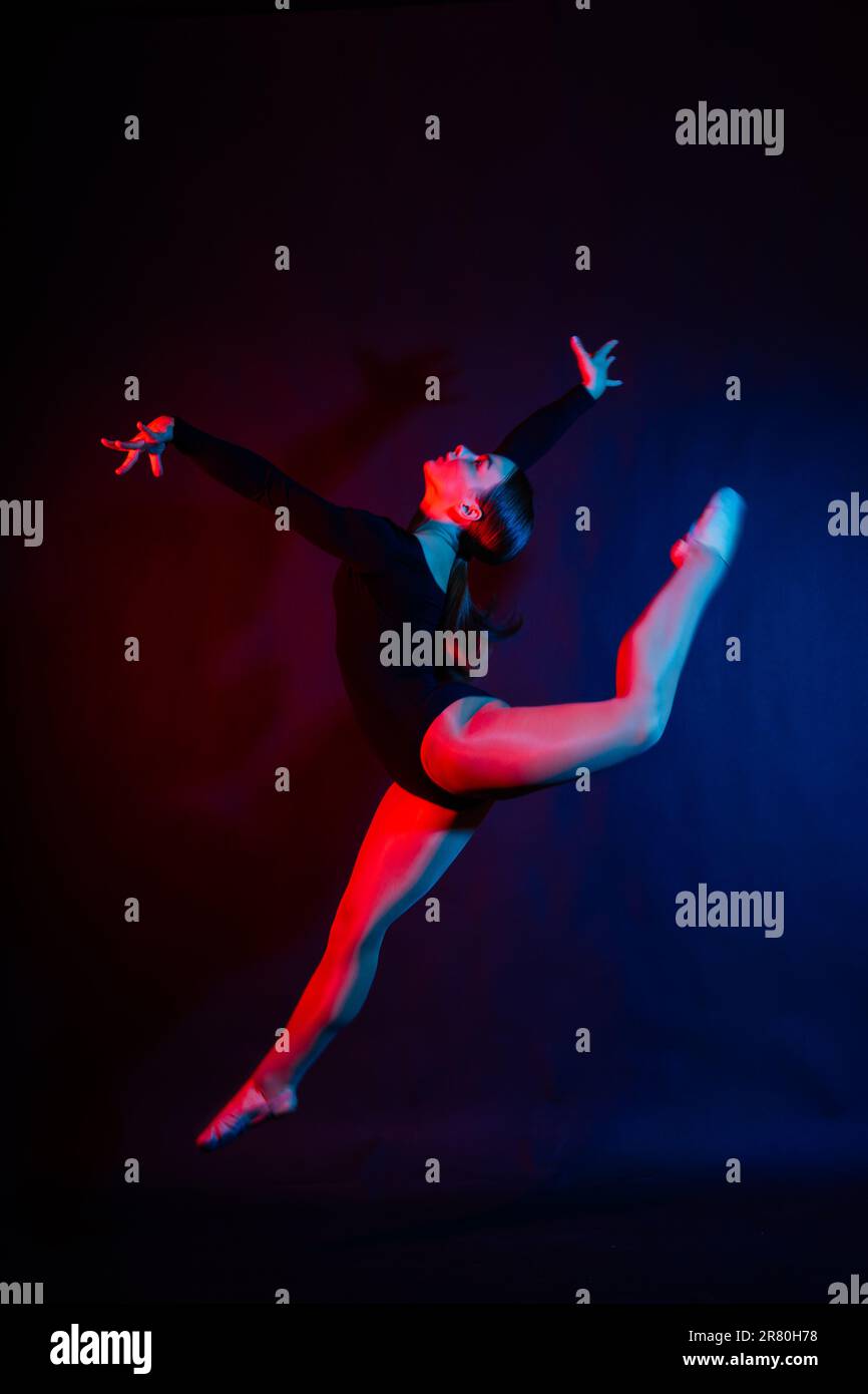 High jump, flight. Little flexible girl, rhythmic gymnastics artist ...