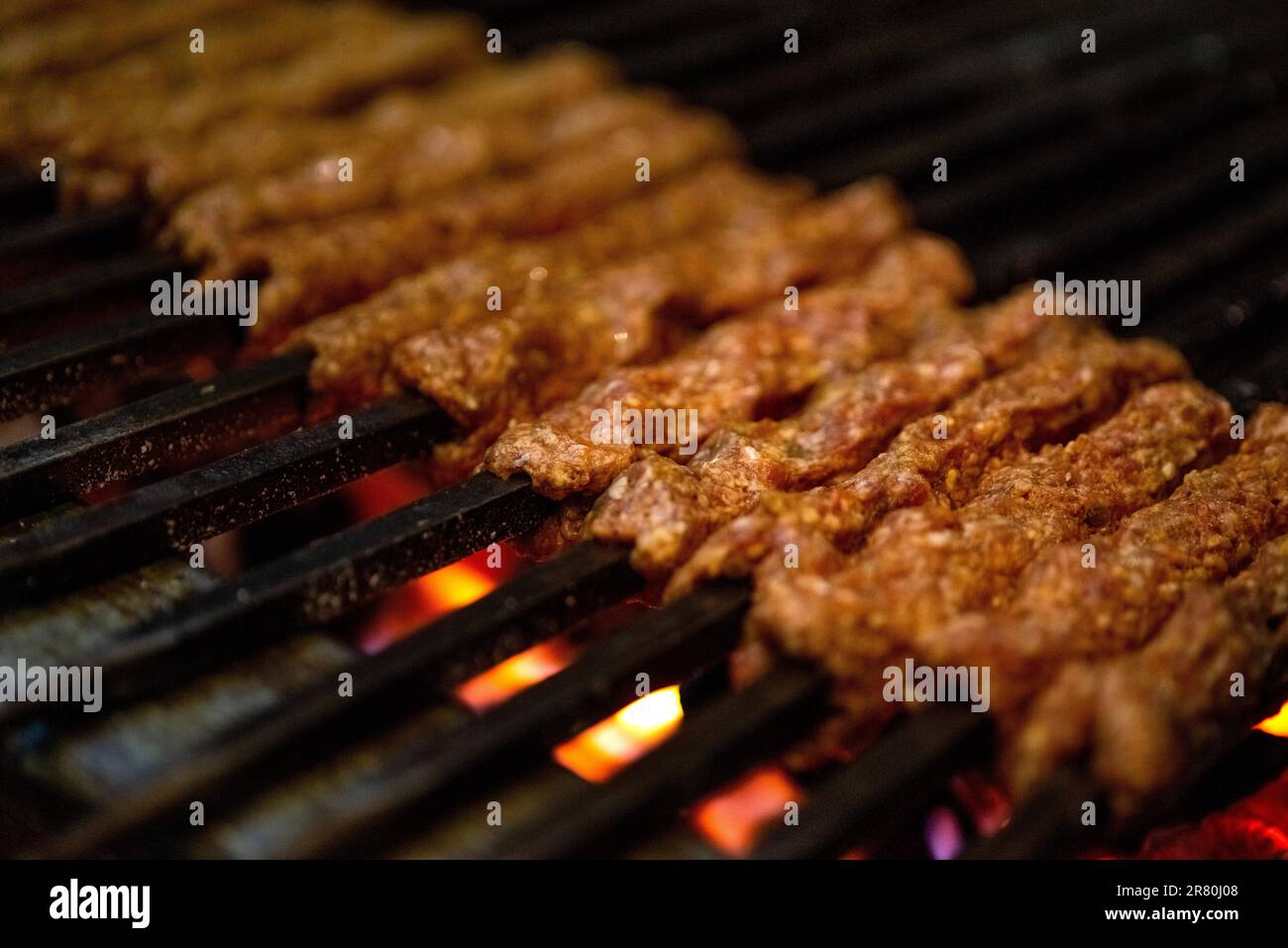 Making Spicy seekh kebabs are being grilled on burning charcoal in ...