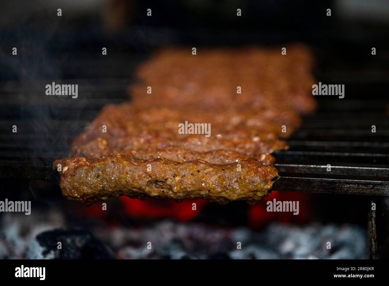 Making Spicy seekh kebabs are being grilled on burning charcoal in ...
