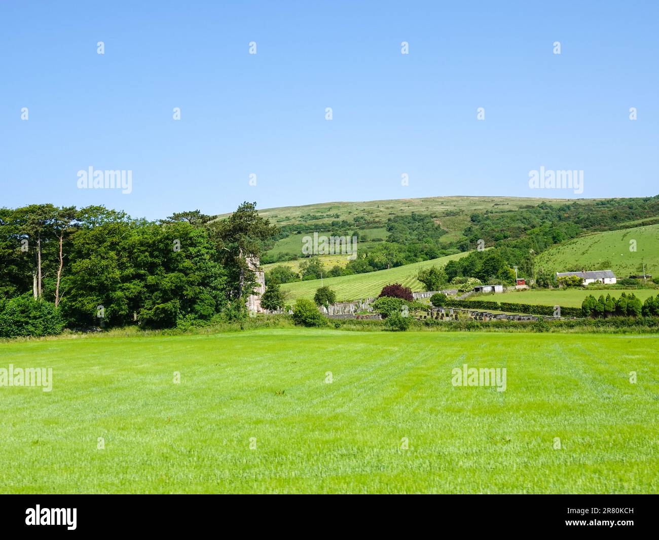 Rolling, green hills with old church and graveyard, cemetery, burial ...