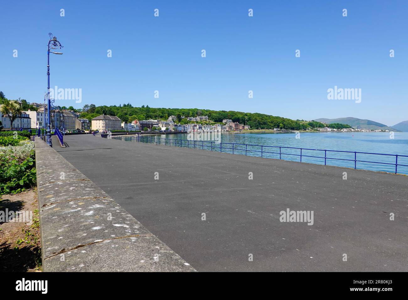 Seaside resort town of Rothesay with people swimming in the bay on a ...