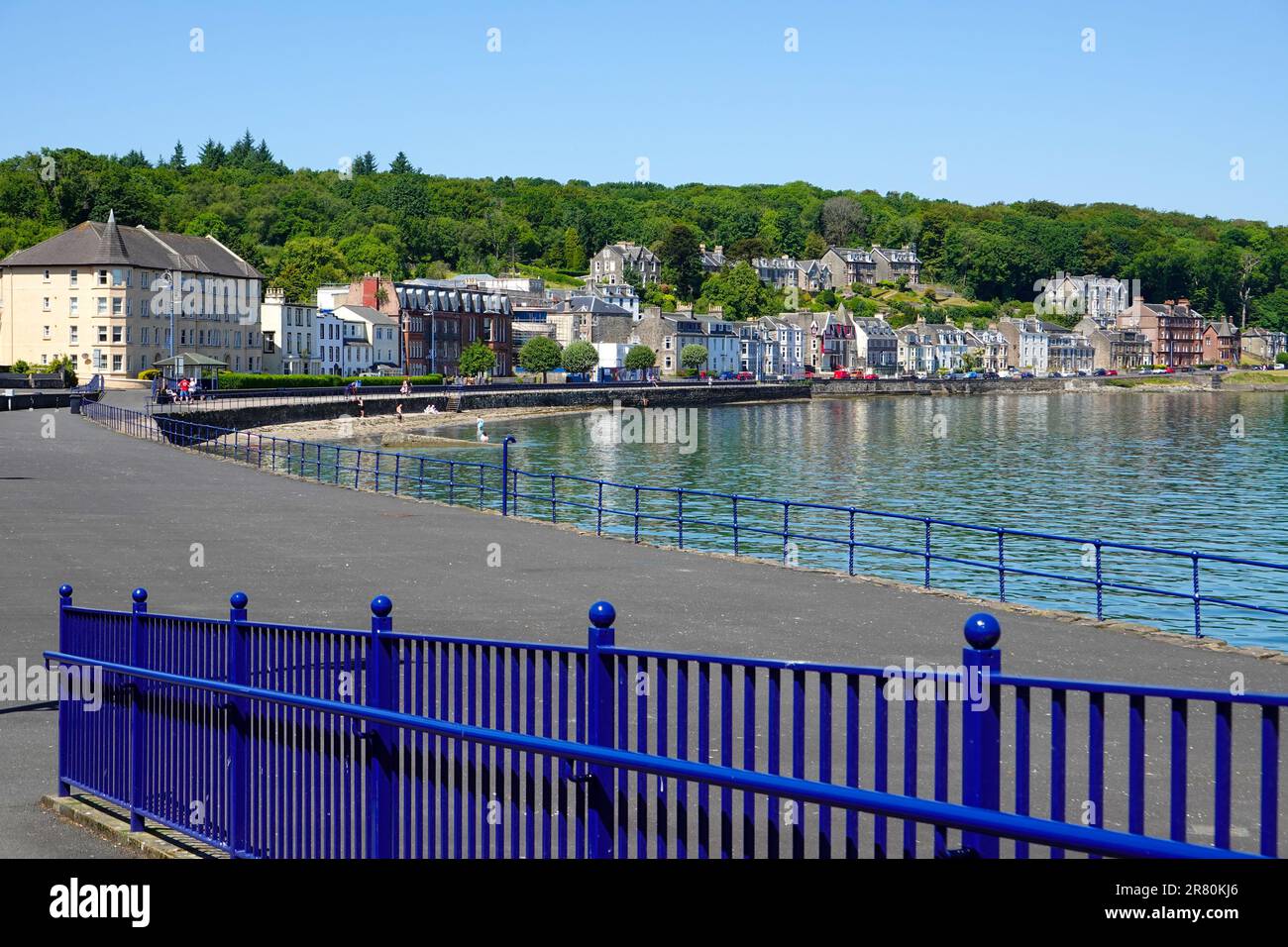 Seaside resort town of Rothesay with people swimming in the bay on a ...