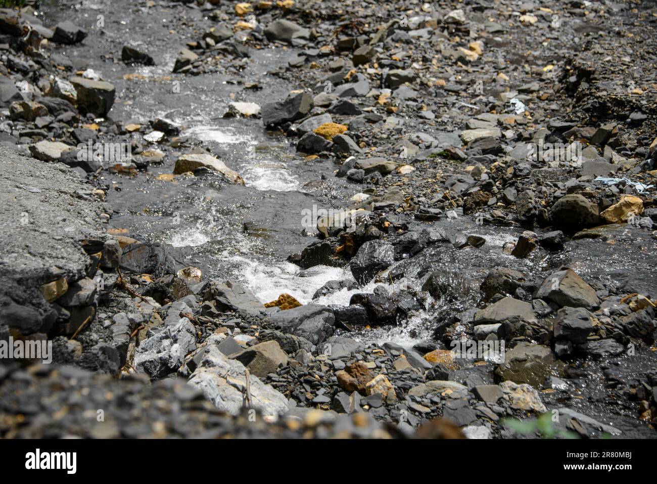 Water flowing over river rocks near mountains in Nathia Gali ...