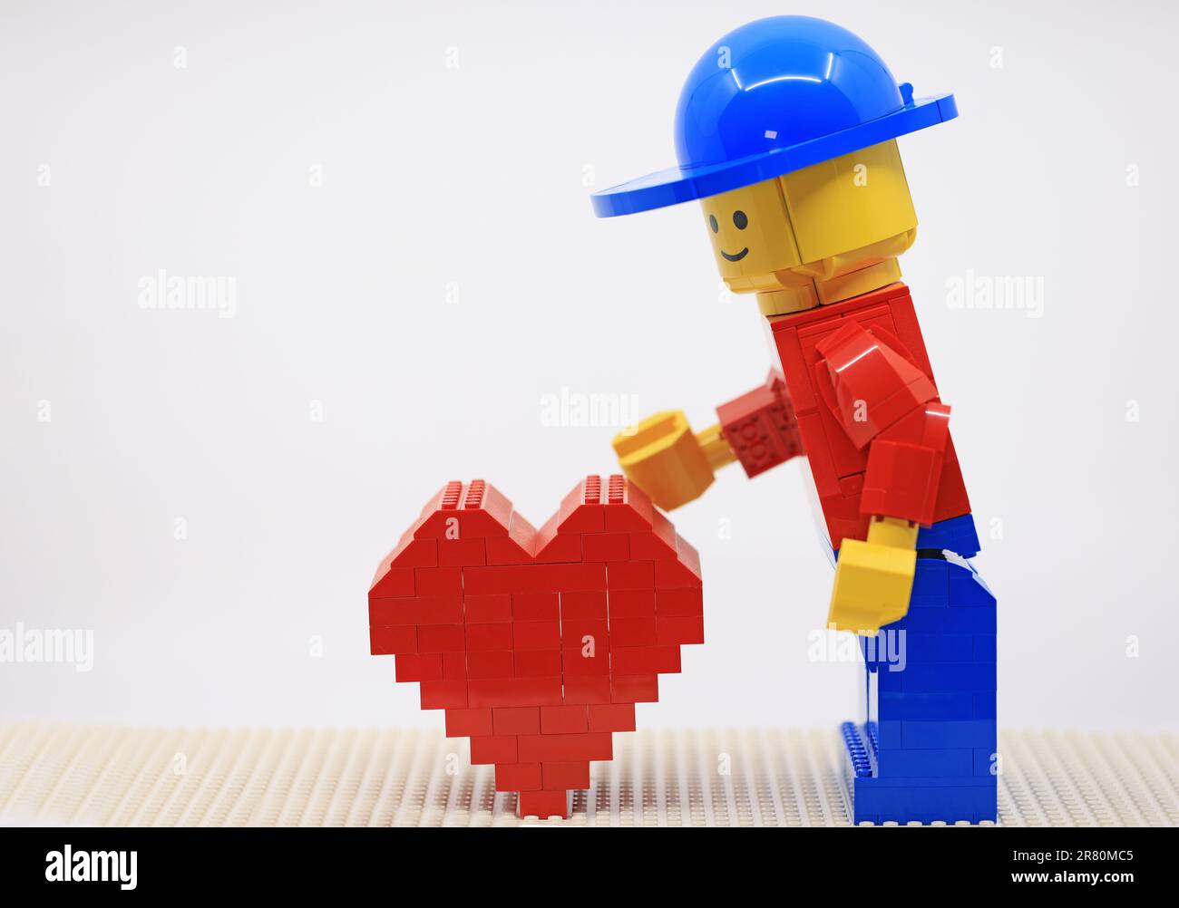 Hong Kong -June 17 2023: giant man pick up small one which holding they ...