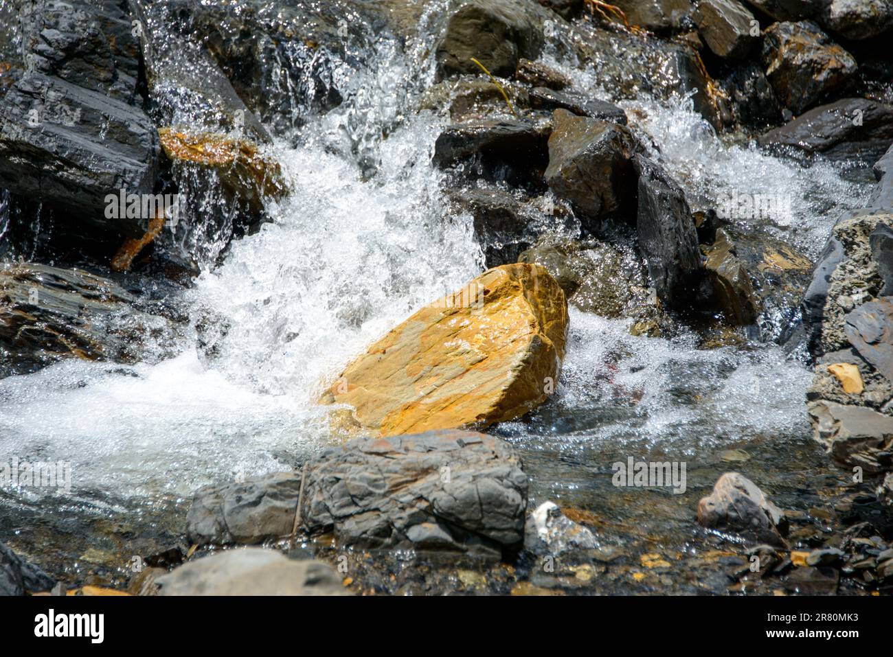 Water flowing over river rocks near mountains in Nathia Gali ...