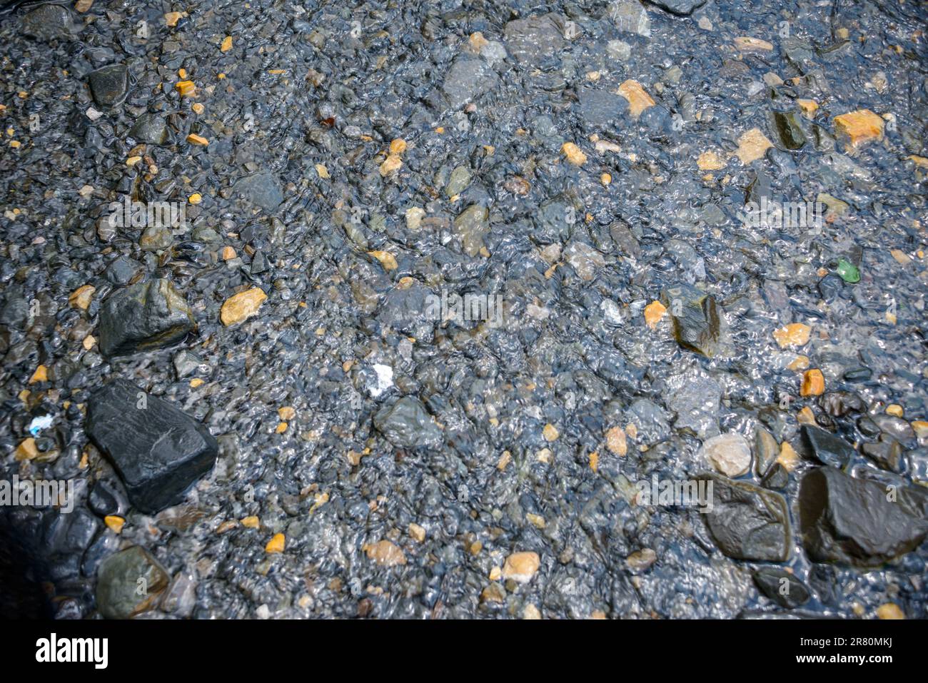 Water flowing over river rocks near mountains in Nathia Gali ...