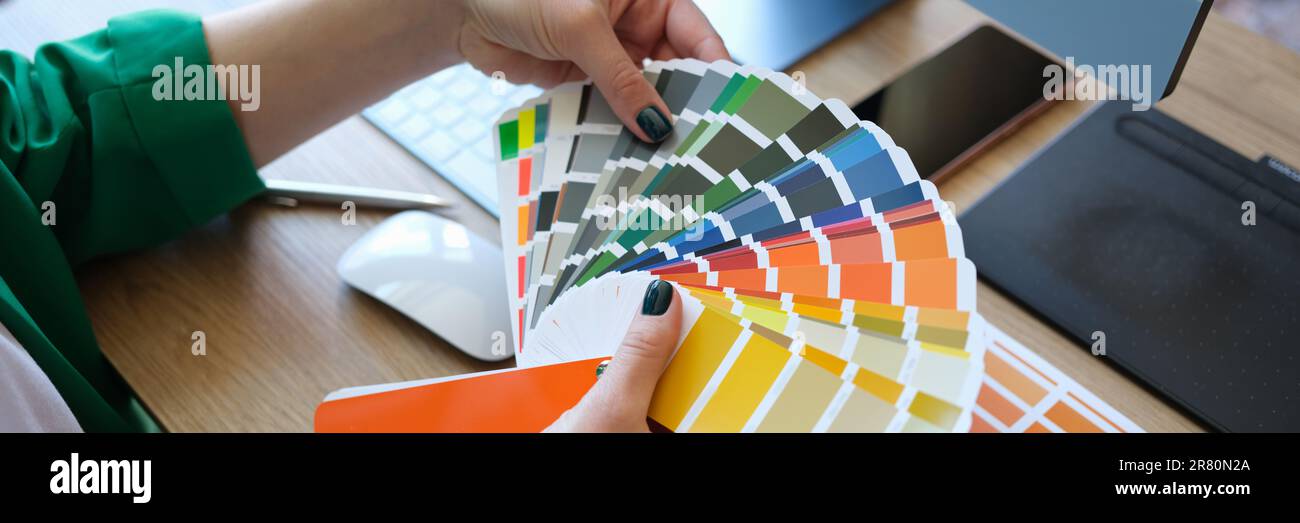 Designer shows color palette of samples of different colors and shades ...
