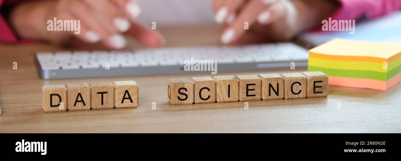 Hands typing on keyboard and data science text on cubes Stock Photo - Alamy