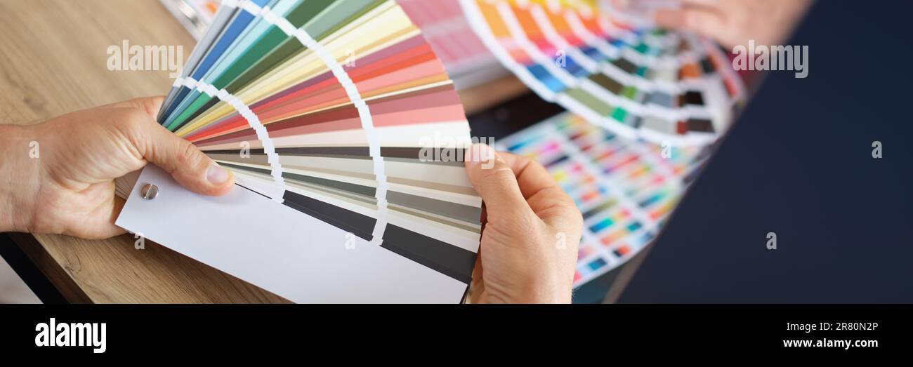 Creative designer advises client and shows color sample in color ...