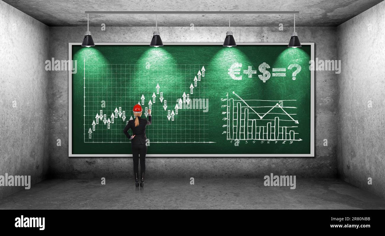 engineer woman in helmet drawing stock exchange statistics on chalk ...