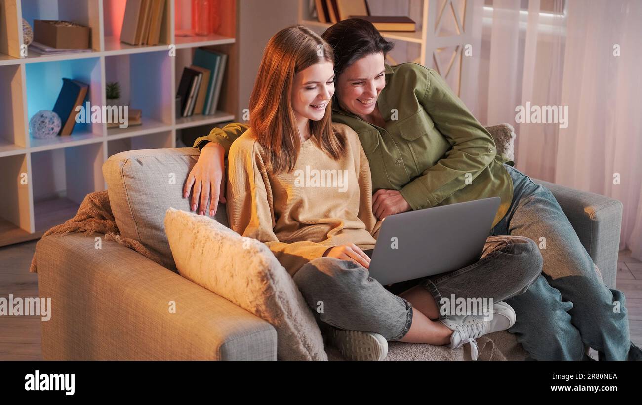Sofa browsing family networking woman daughter Stock Photo - Alamy