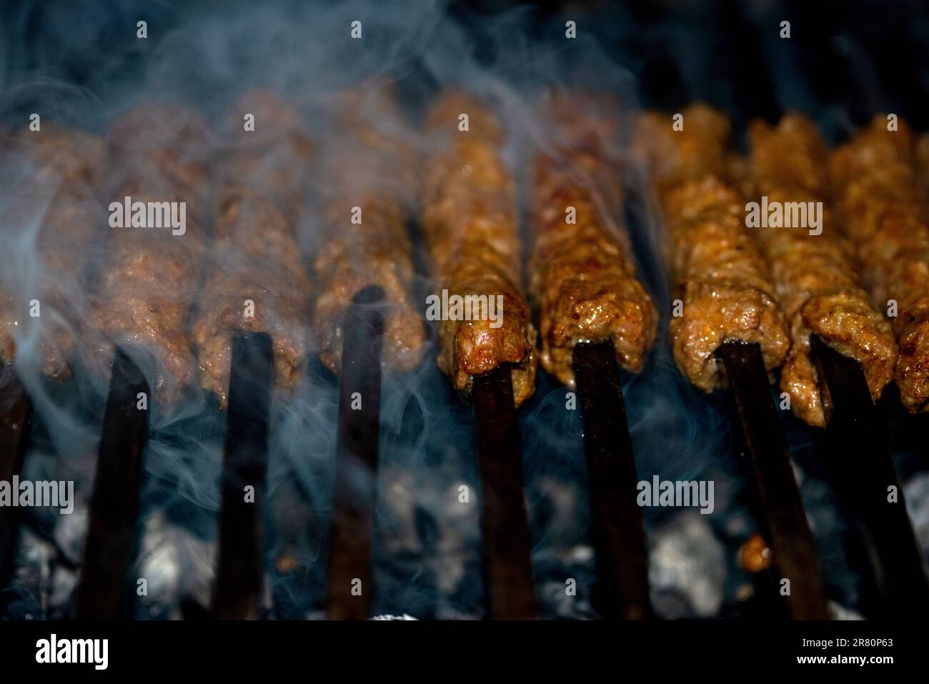 Making Spicy seekh kebabs are being grilled on burning charcoal in ...