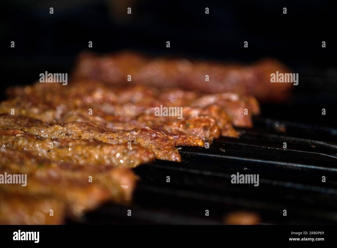 Making Spicy seekh kebabs are being grilled on burning charcoal in ...