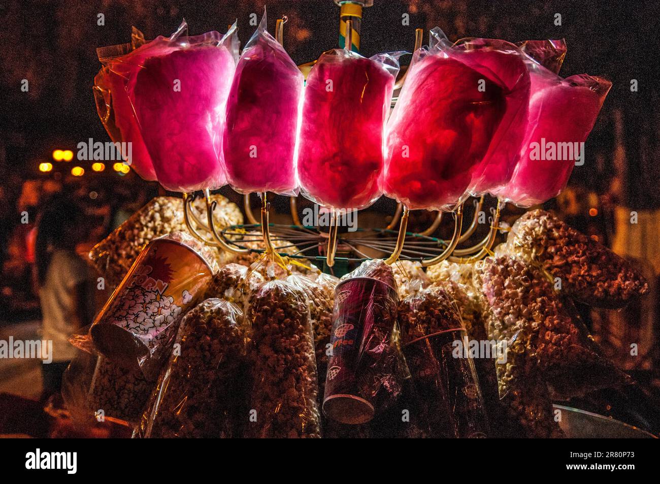 popcorn & cotton candy illuminated at night at a street stall. Phnom ...