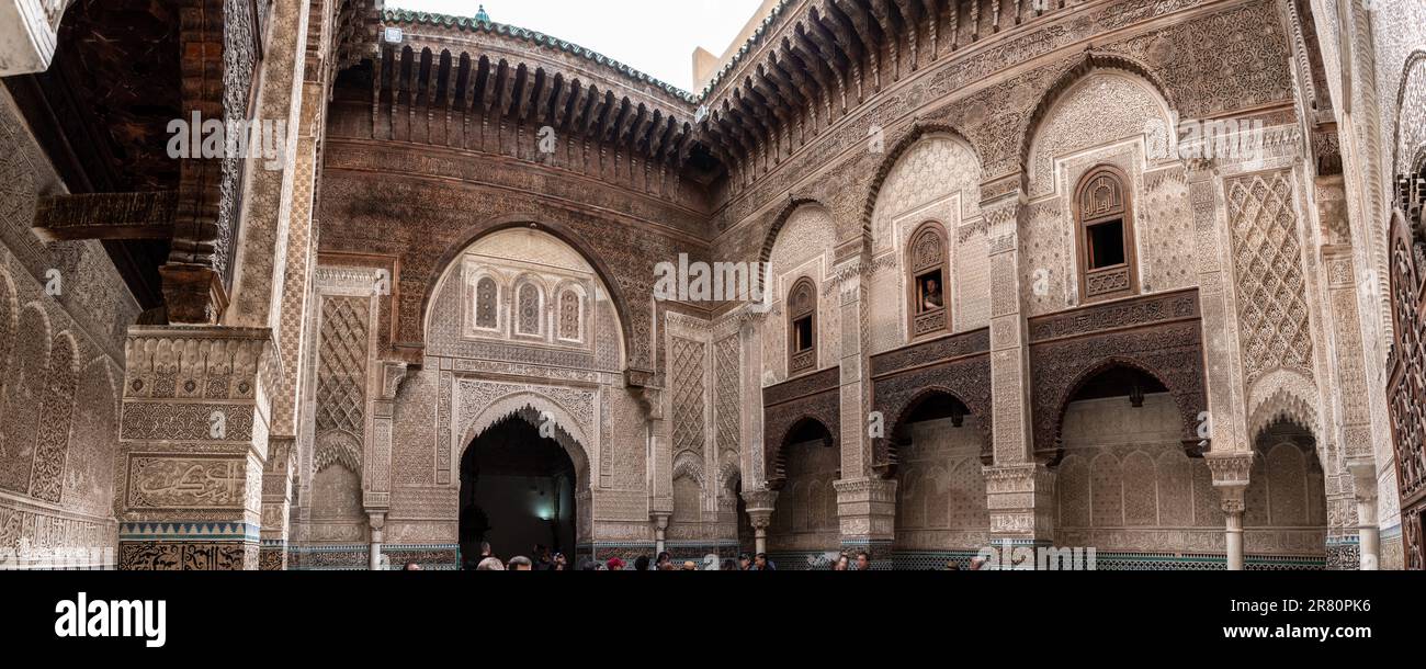 Rich decorated facade in the courtyard of the Medersa Attarine in Fes ...