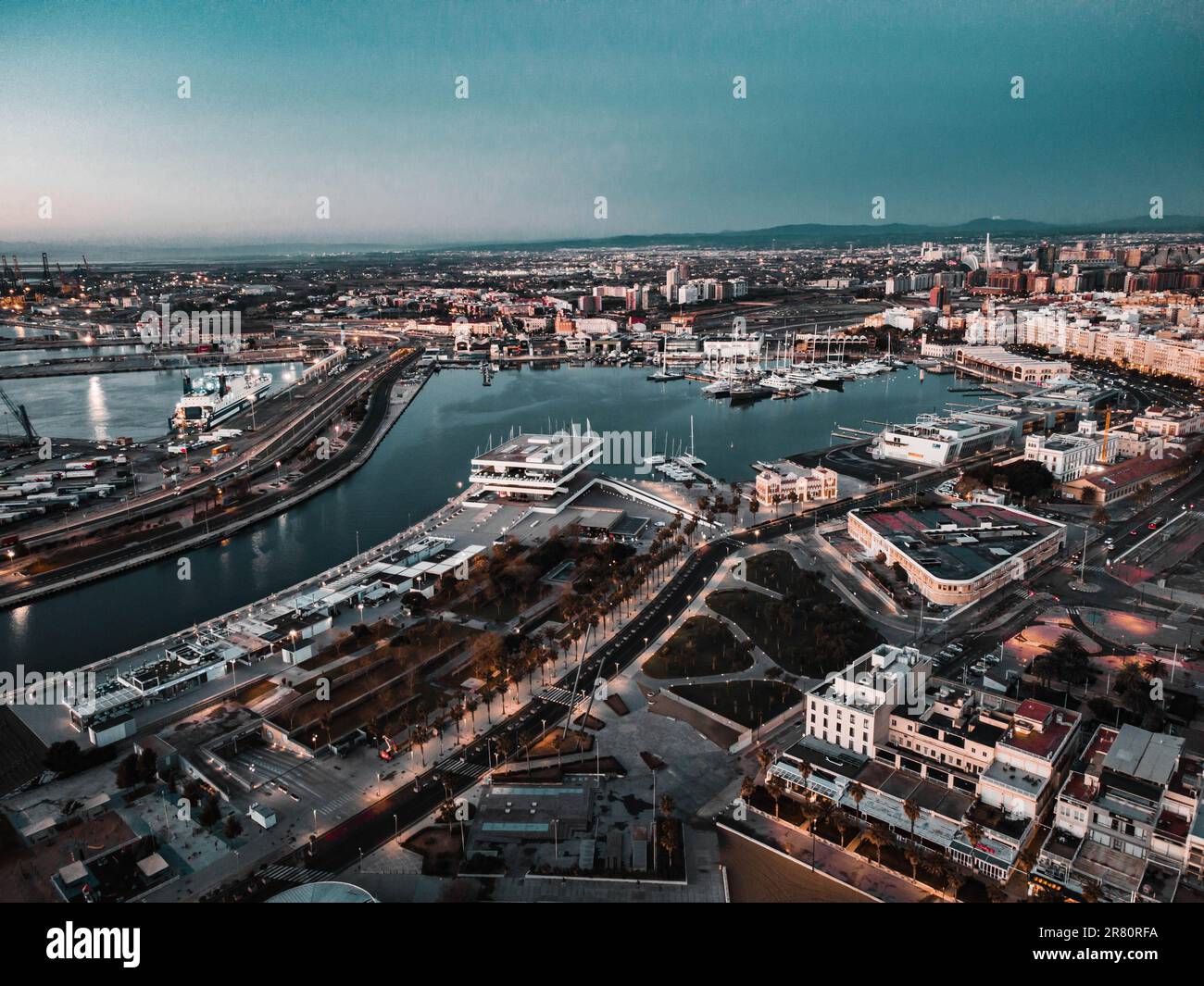 An aerial view of a bustling Valencia harbor, with busy highways below ...