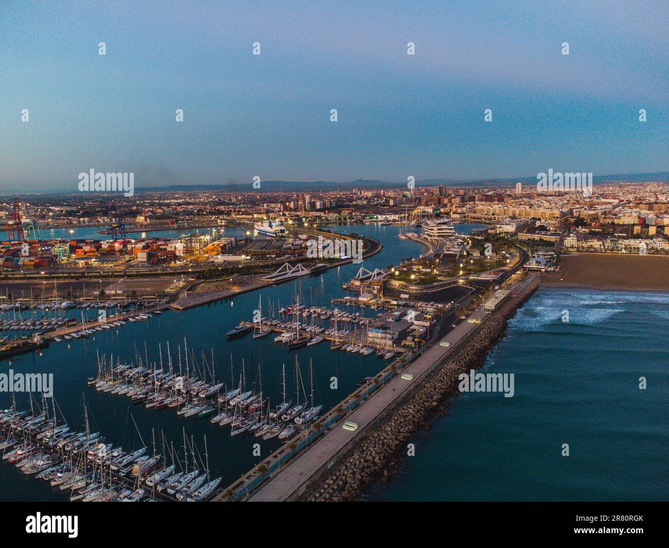 An aerial view of a bustling Valencia harbor, with busy highways below ...