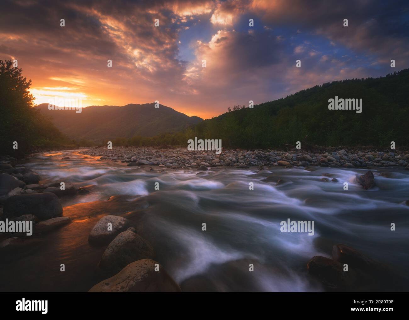 fast mountain river flowing In beautiful sunset time Stock Photo - Alamy