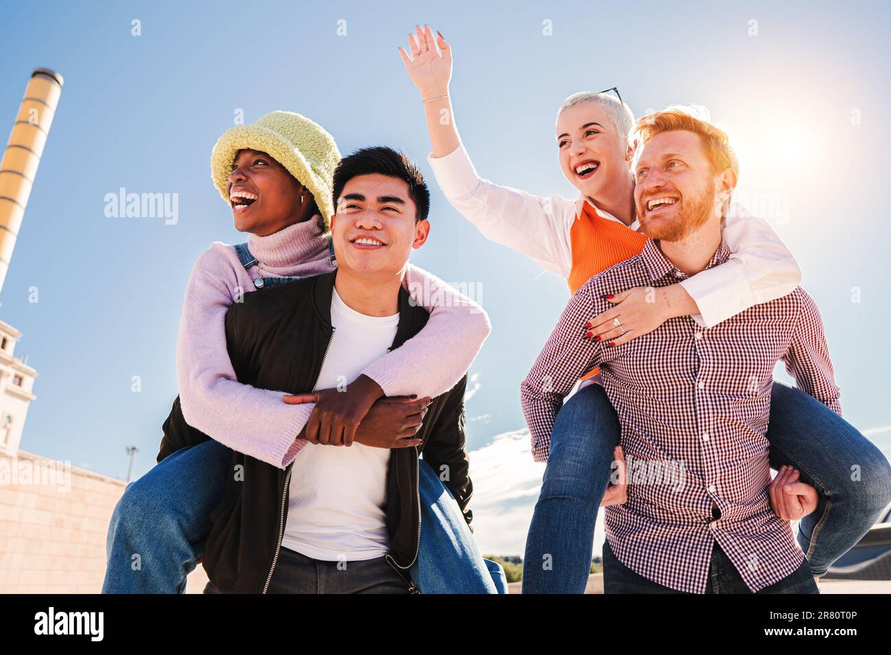 Happy couples having fun on a weekend activity. Two males giving a ...