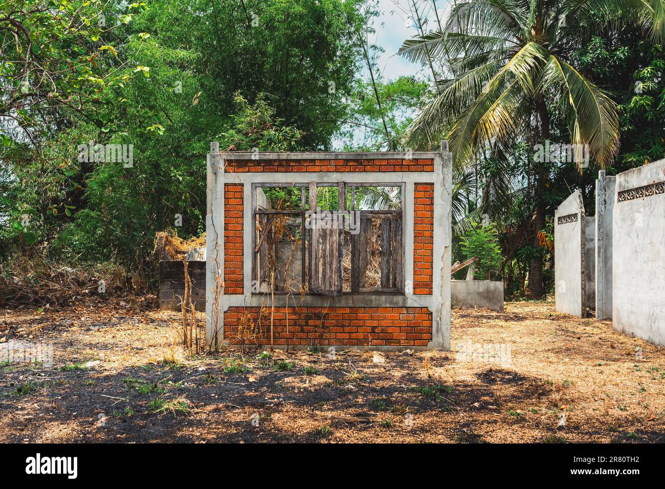 Exterior of old abandoned brick house with broken doors and windows. An ...