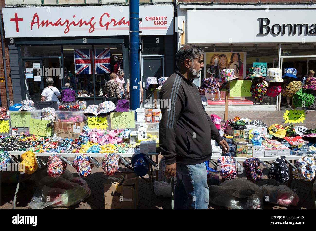 Stallholder in front of his general goods stall at the weekly market in ...