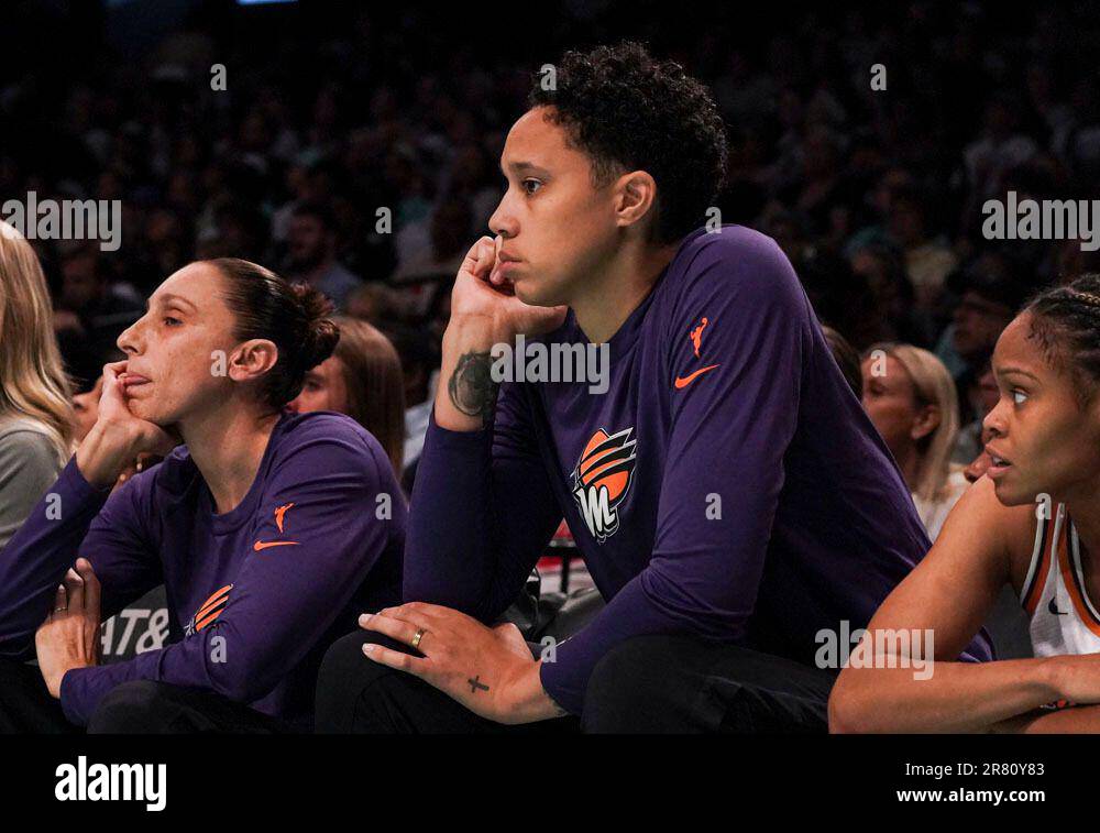 Phoenix Mercury center Brittney Griner, center, and teammate Diana Taurasi, left, watch from the ...