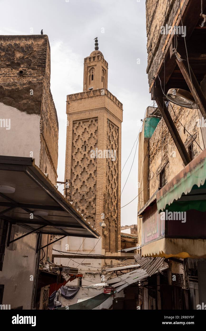 Scenic minaret of a small mosque in between residential houses in the ...