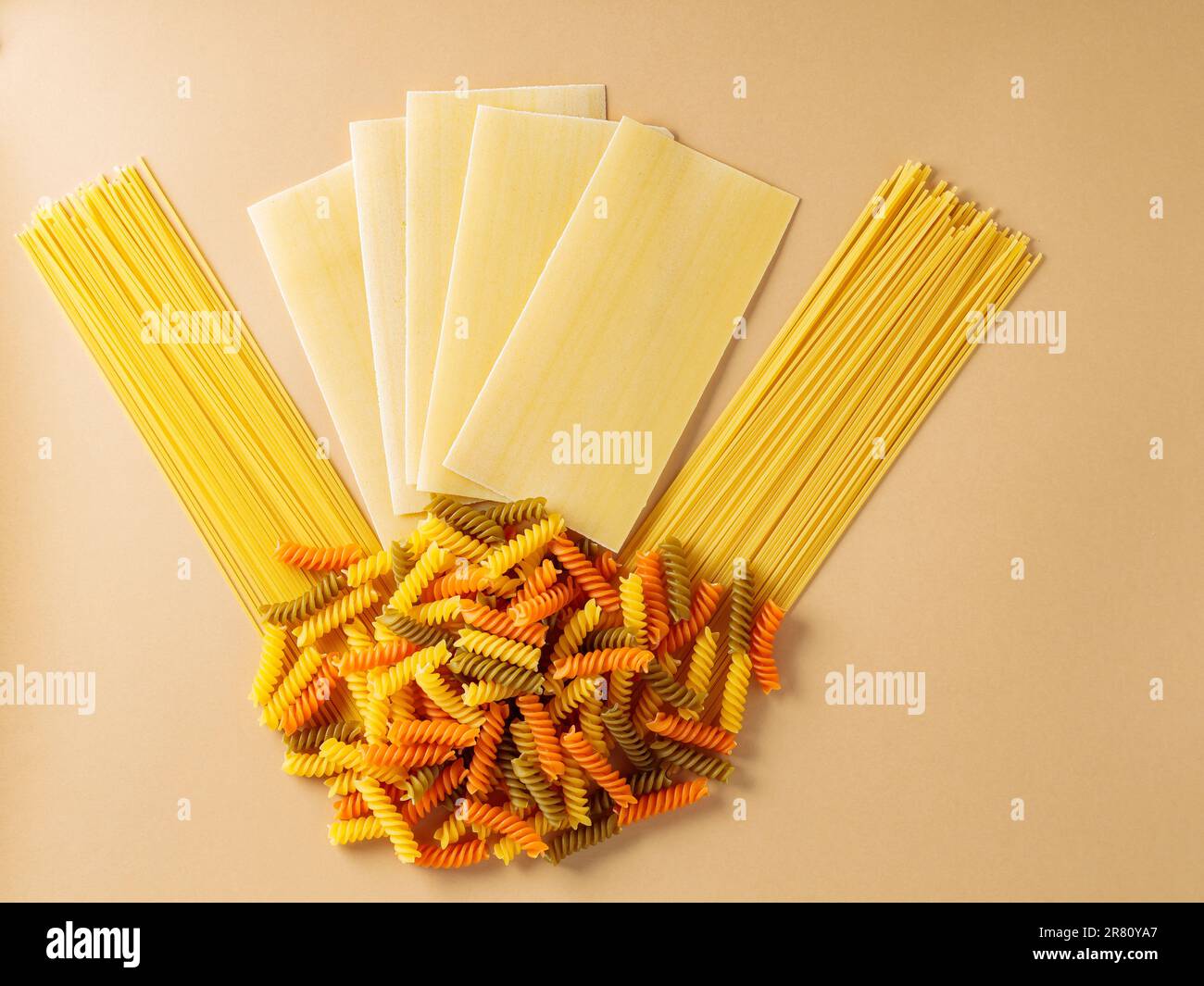 Pasta. Different types of raw pasta on a beige background. Creative ...