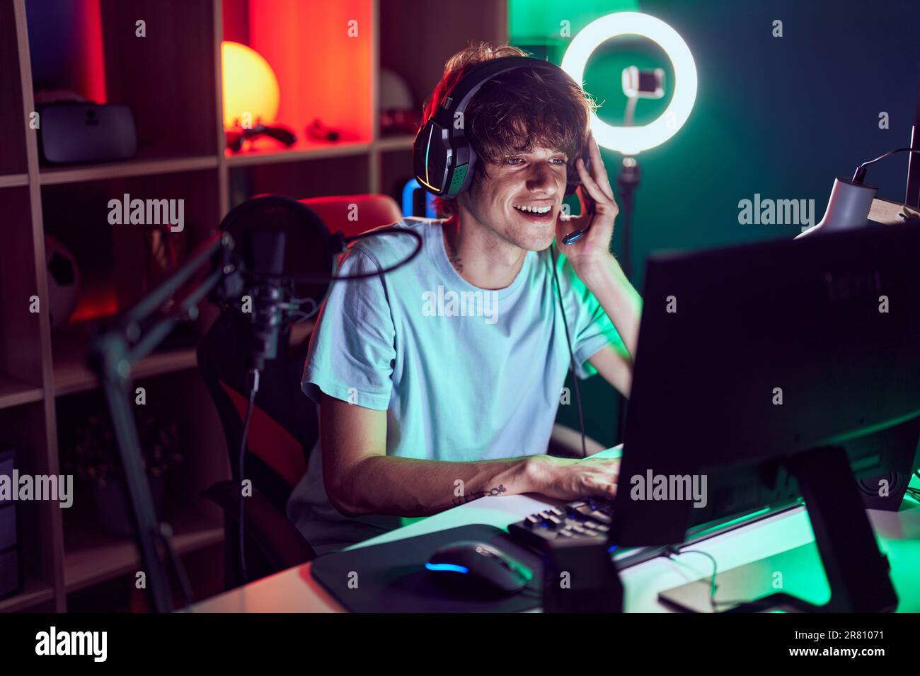 Young blond man playing video game using computer at gaming room Stock ...