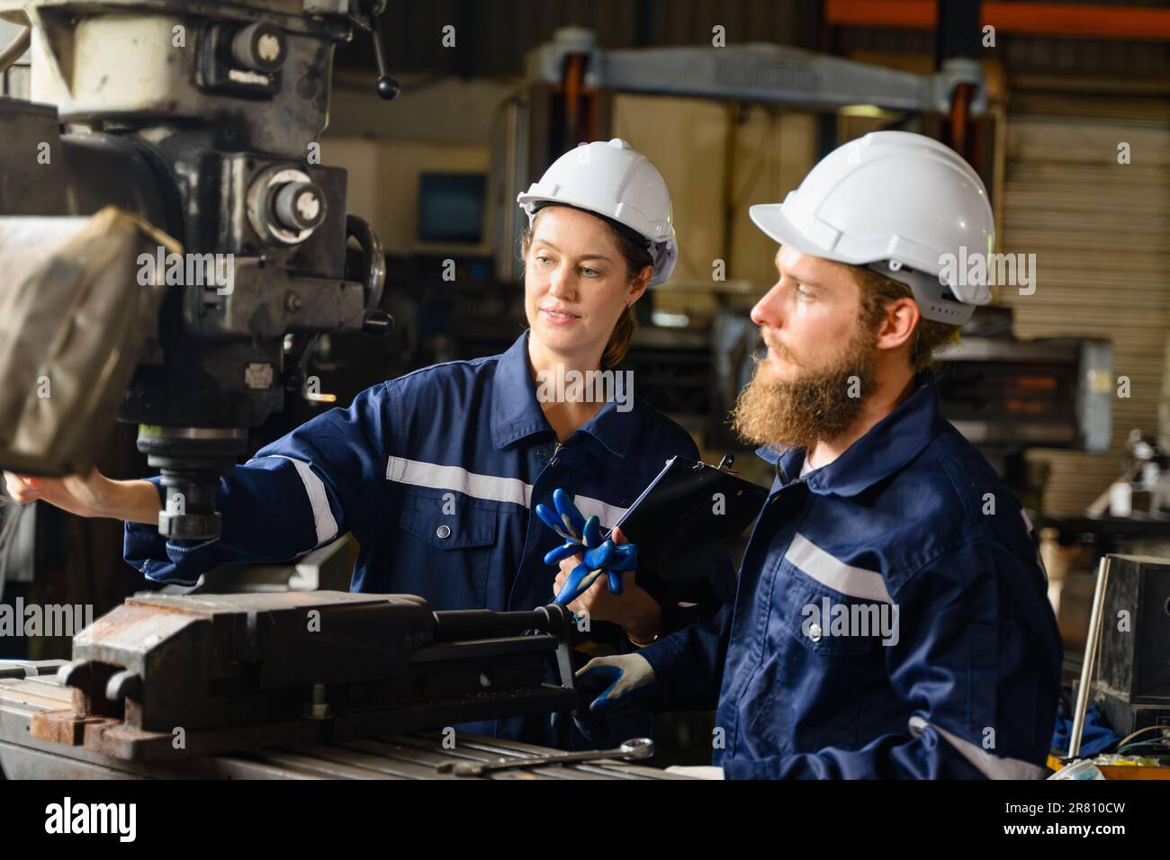 Mechanical engineers repairing engine machine at factory Stock Photo ...