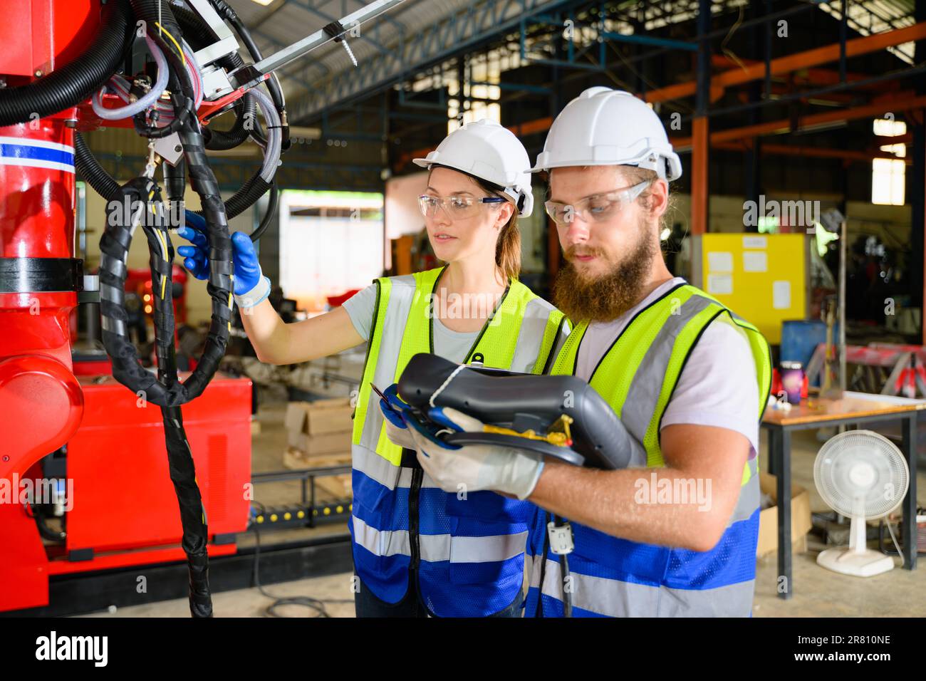 Mechanical engineers repairing engine machine at factory Stock Photo ...