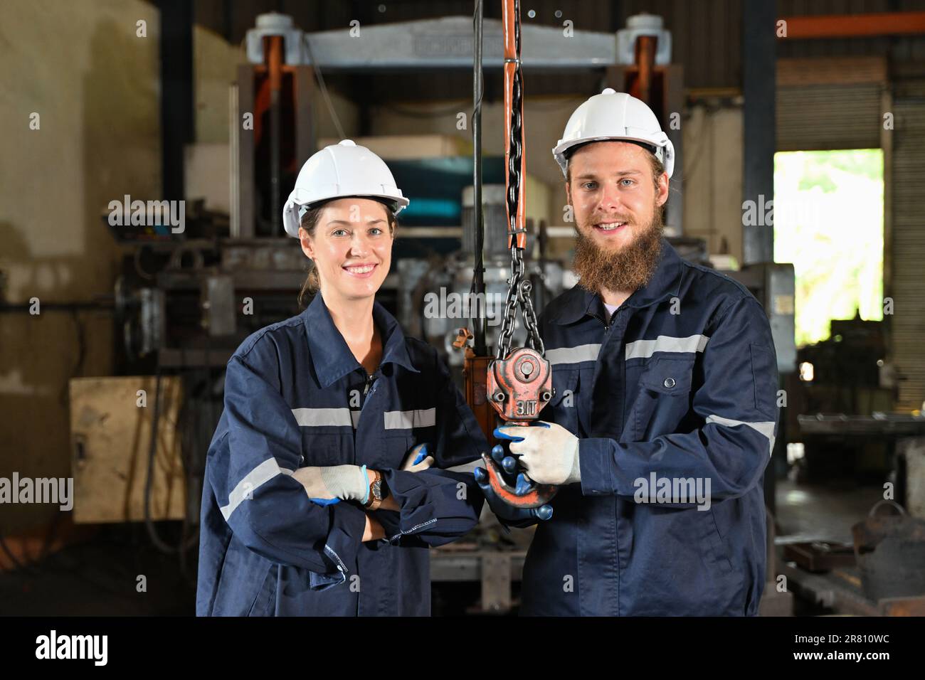 Mechanical engineers repairing engine machine at factory Stock Photo ...