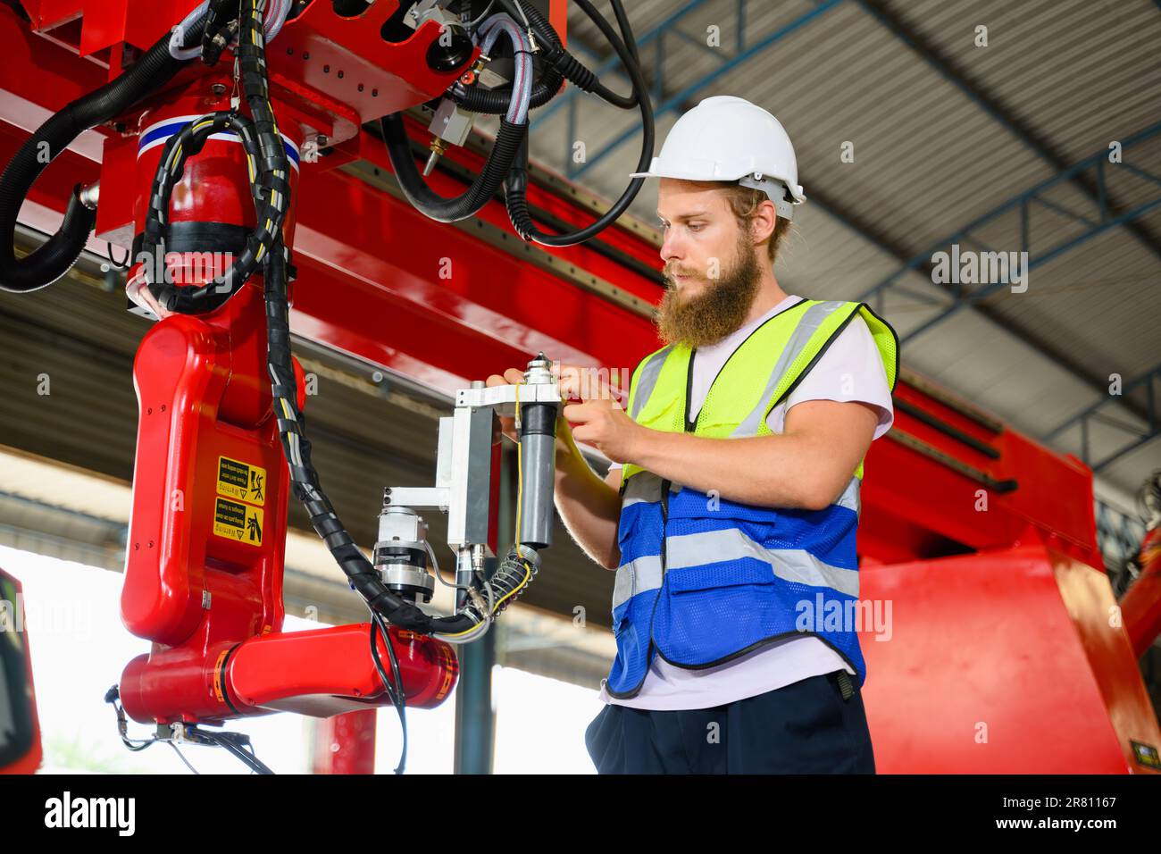 Mechanical engineer repairing engine machine at factory Stock Photo - Alamy