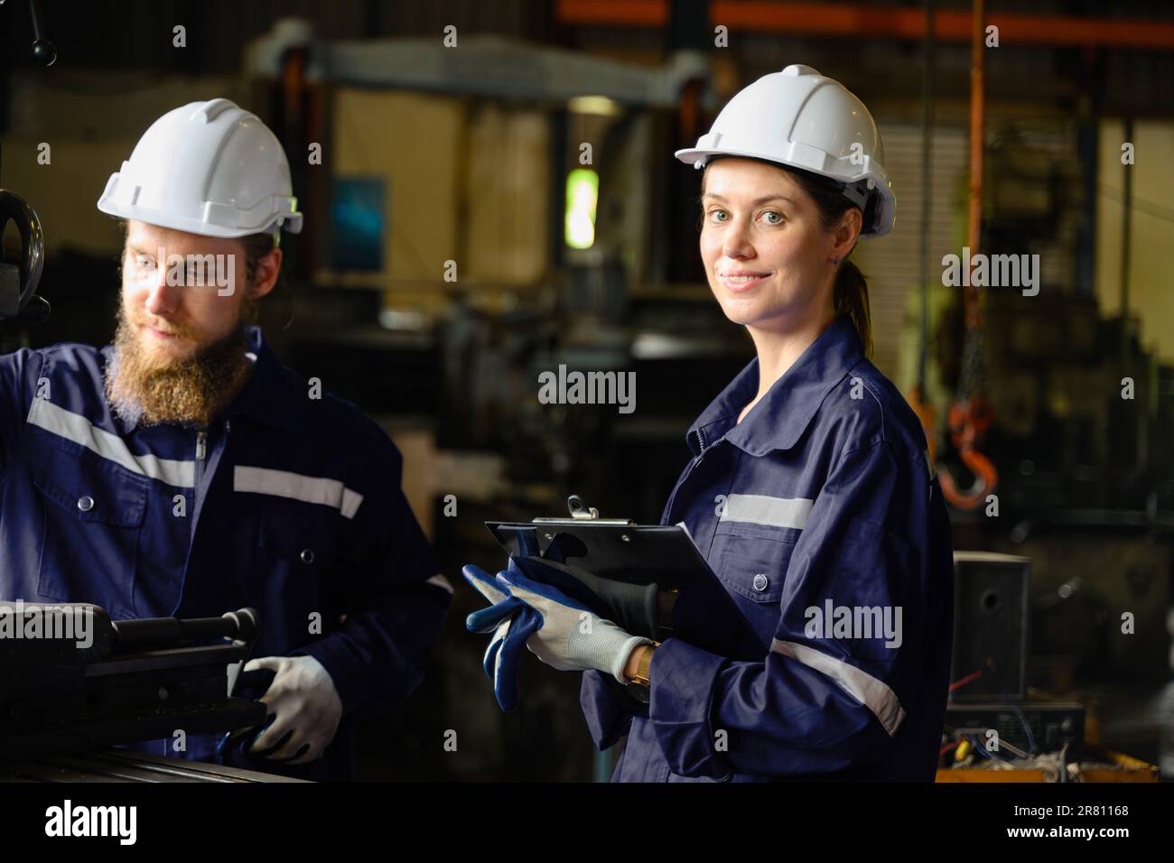 Mechanical engineers repairing engine machine at factory Stock Photo ...